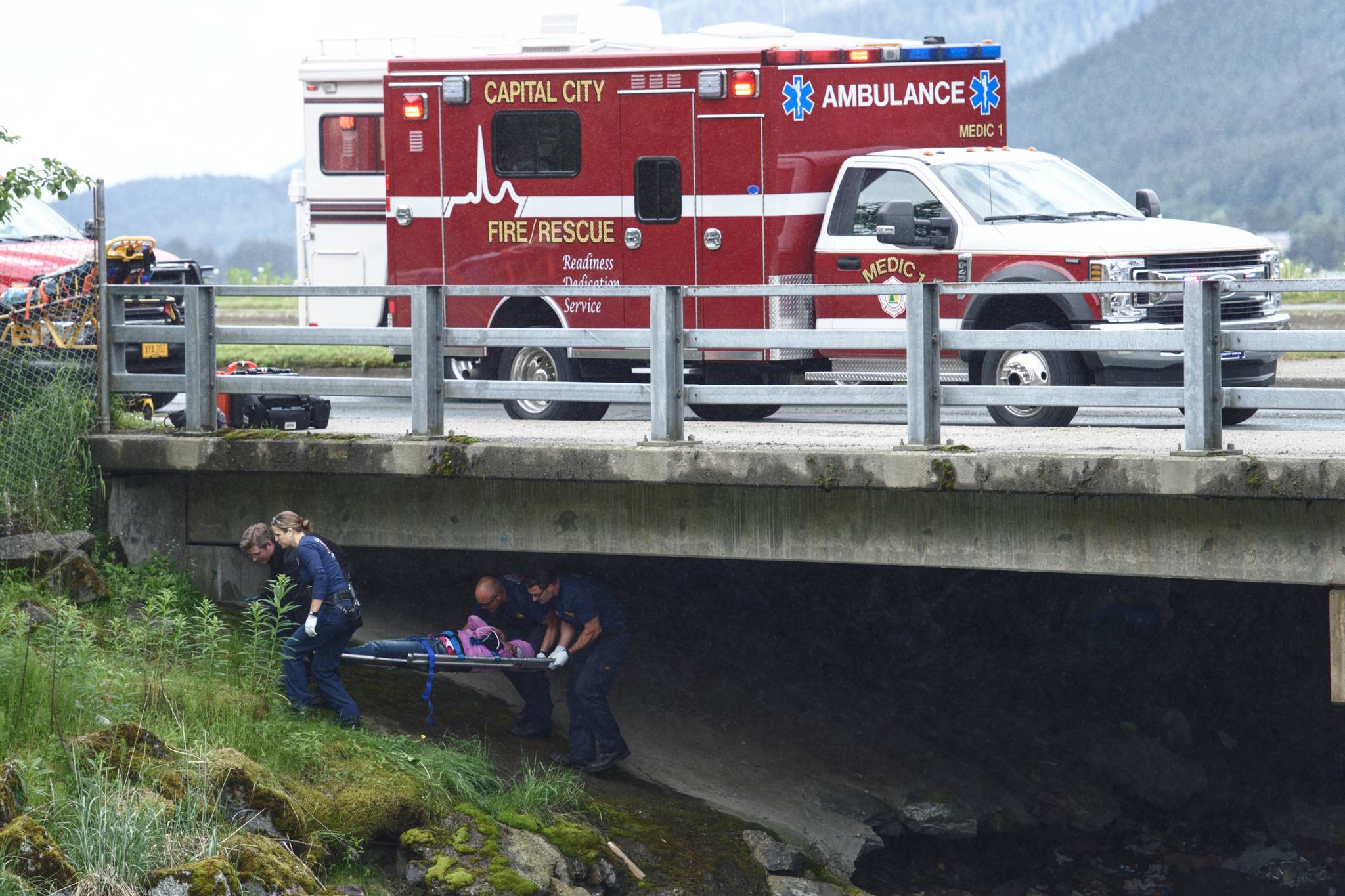 Rescuers help person under bridge | Juneau Empire