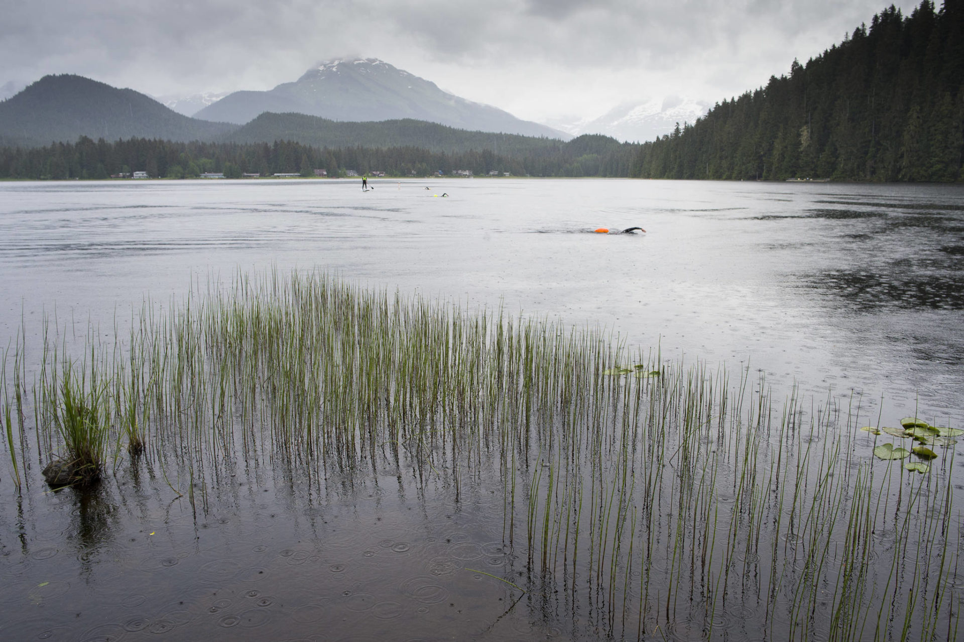 Photos: Triathlon swimmers train at Auke Lake | Juneau Empire